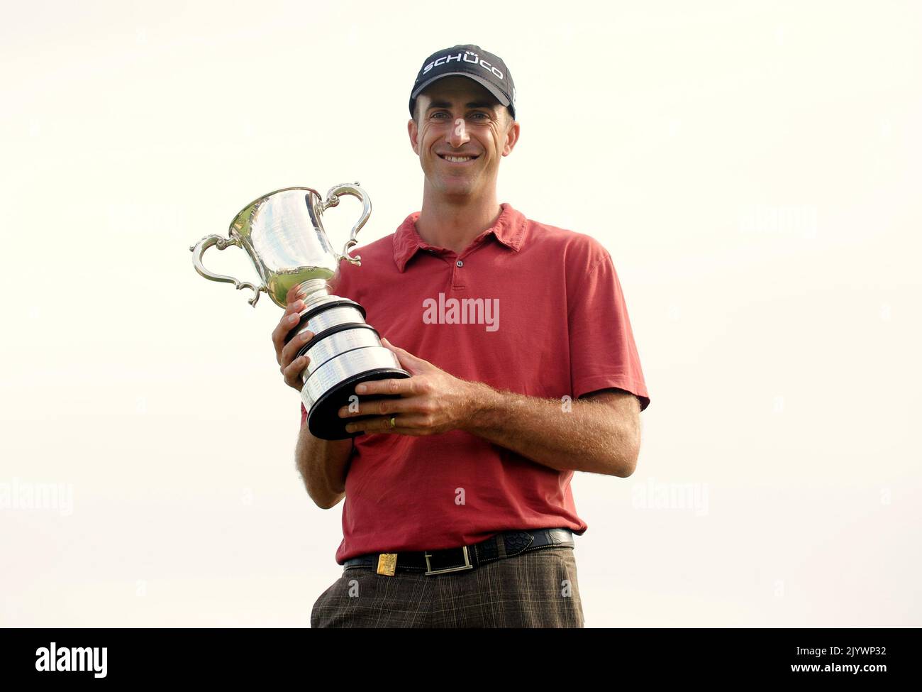Australian golfer Geoff Ogilvy poses for photographs with his trophy ...