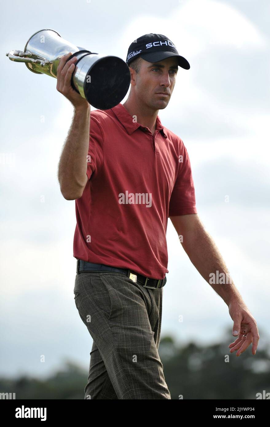 Australian golfer Geoff Ogilvy poses for photographs with his trophy ...