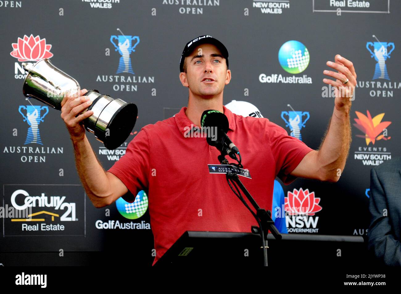 Australian golfer Geoff Ogilvy poses for photographs with his trophy ...