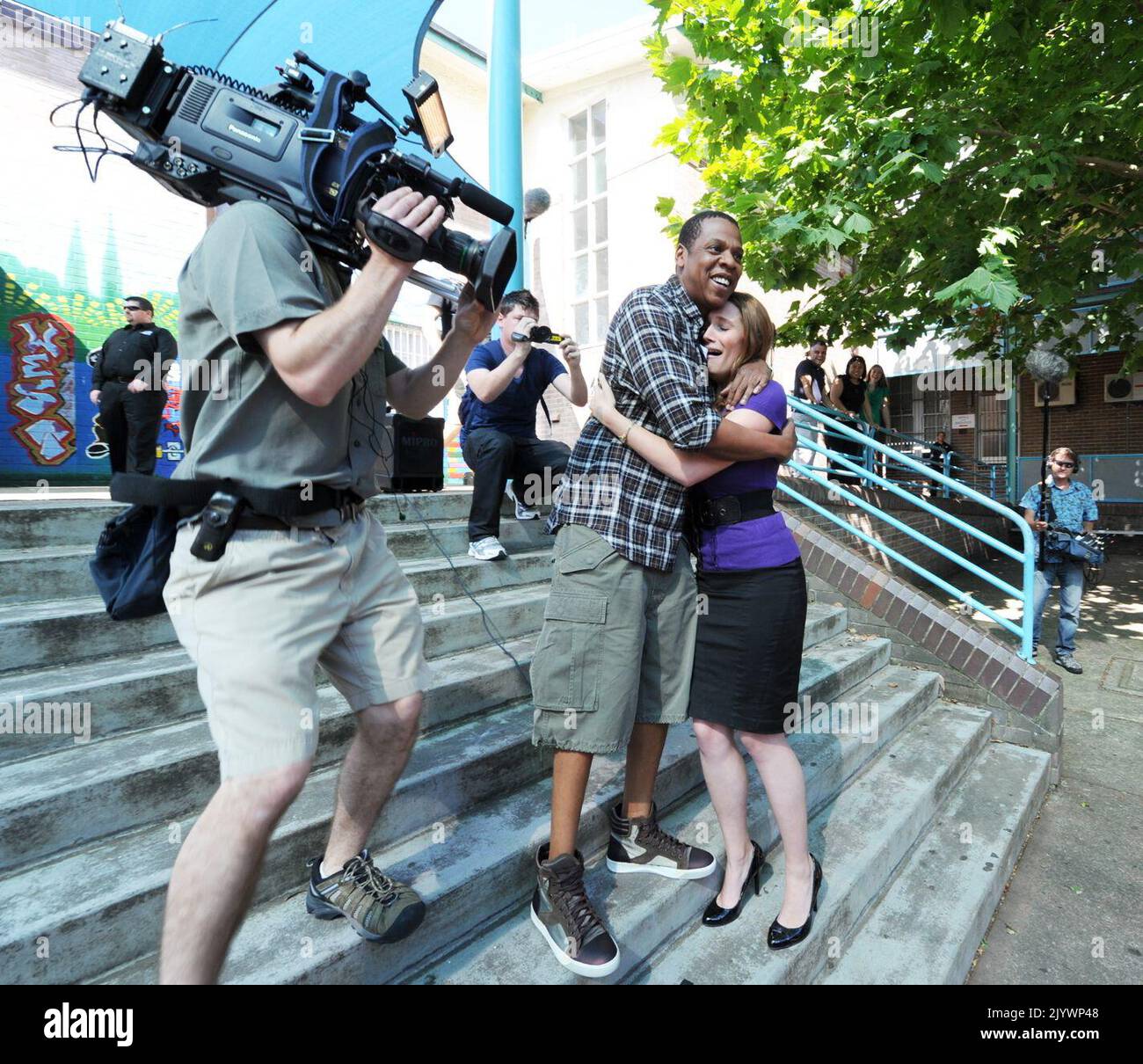 Jay Z embracing school teacher Polly Dunning during a surprise visit to ...