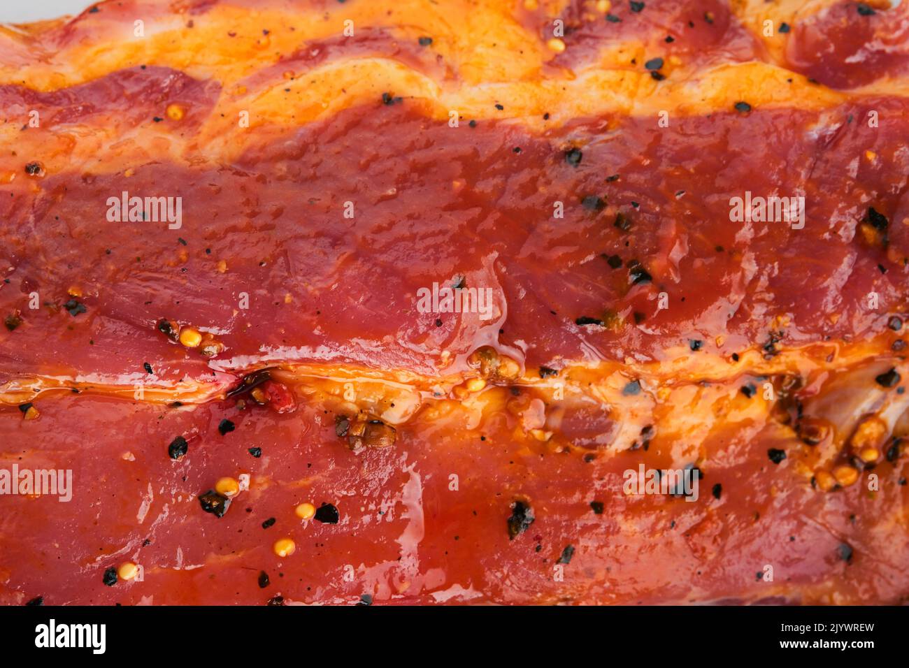 Pork ribs. Raw meat. Raw pork ribs in marinade with spices, rosemary ...