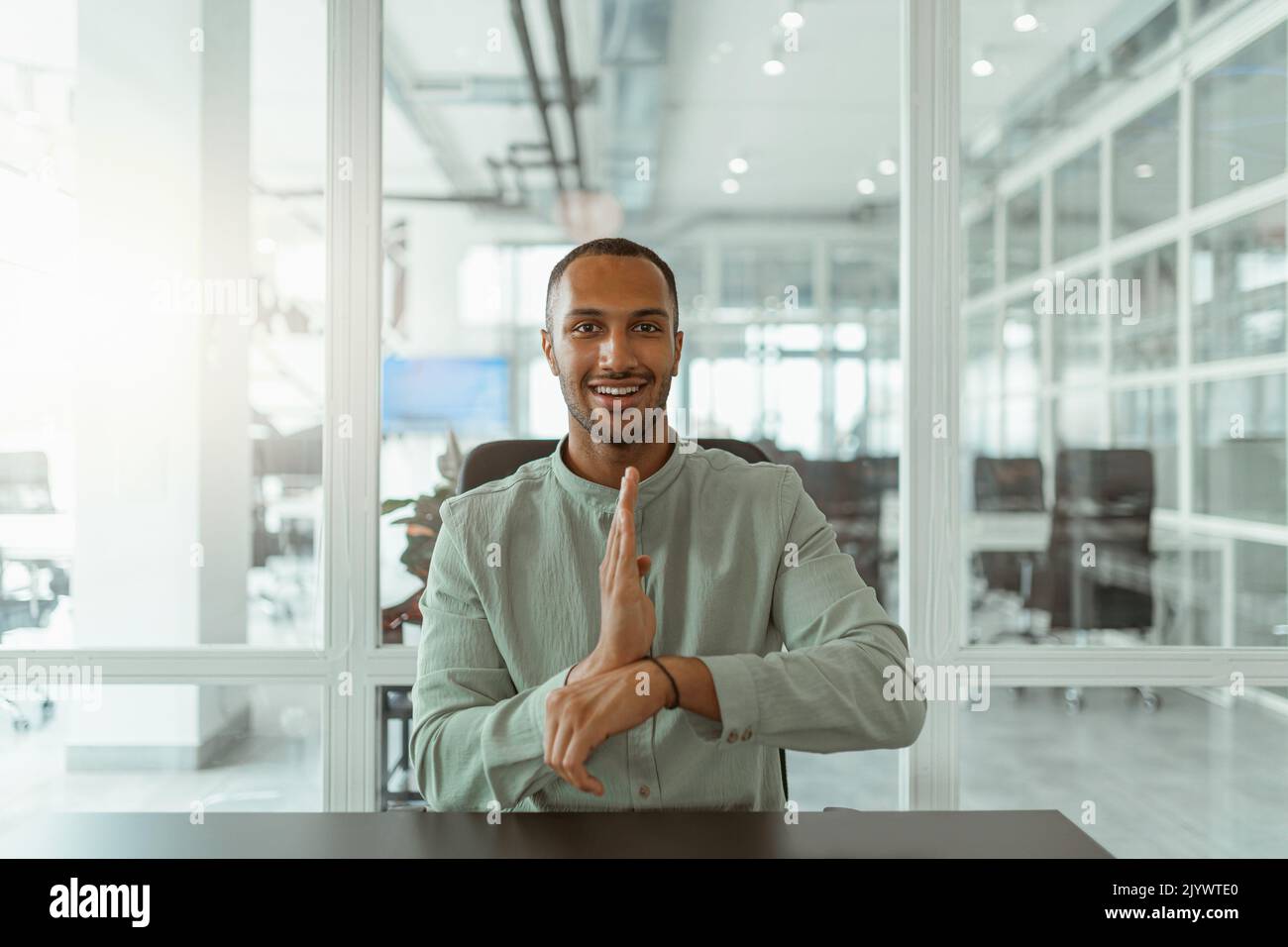 African businessman using sign language while talking online with ...
