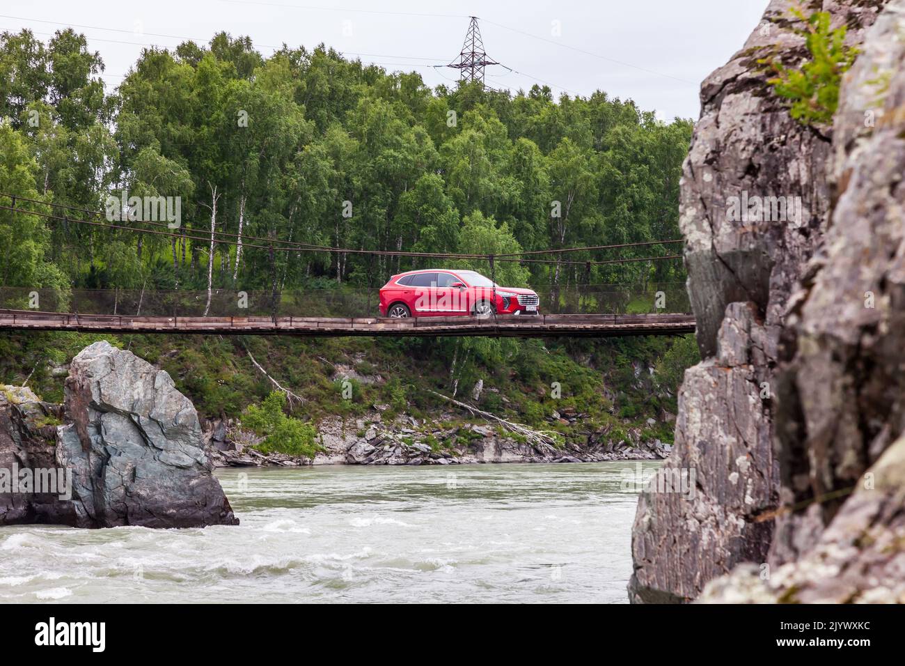 Altai, Russia - 08. 20. 2022: Red Haval Jolion car rides on a wooden ...