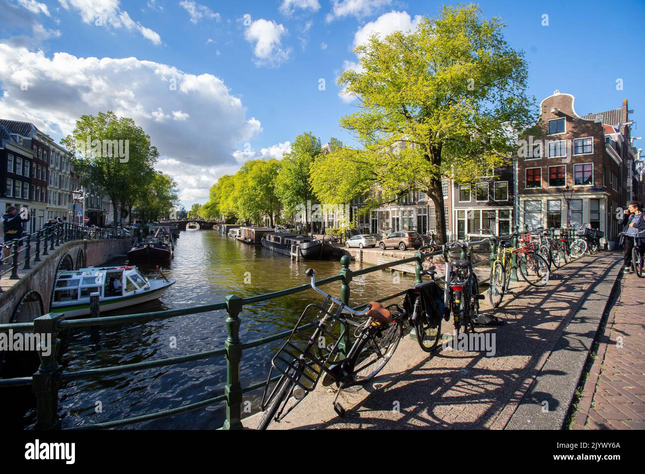 View of Amsterdam's canal from a bridge with chained bicycles Stock ...