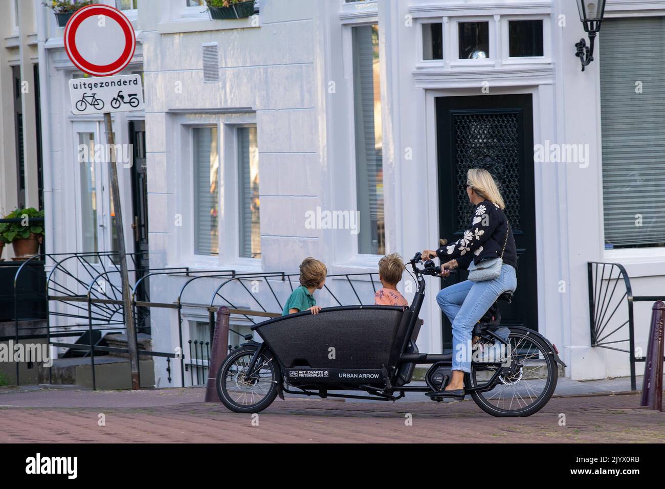 A mother taking her kids for a ride with her bike,at Amsterdam ...
