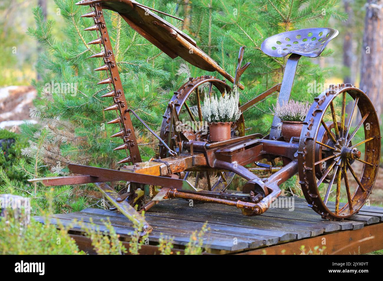 Old fashioned installation with ceramic pot, agricultural equipment and ...