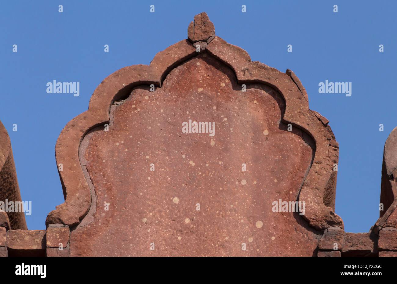 close up of merlon on wall of Jama Masjid mosque in Delhi against blue ...