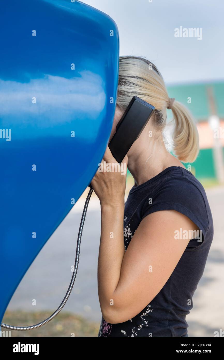 woman holding a telephone receiver near her ear. Man talking on the ...