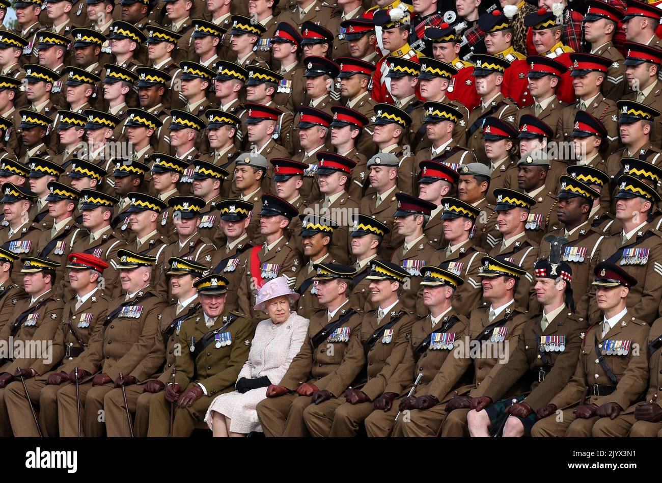 File photo dated 28/09/2015 of Queen Elizabeth II with soldiers for a ...