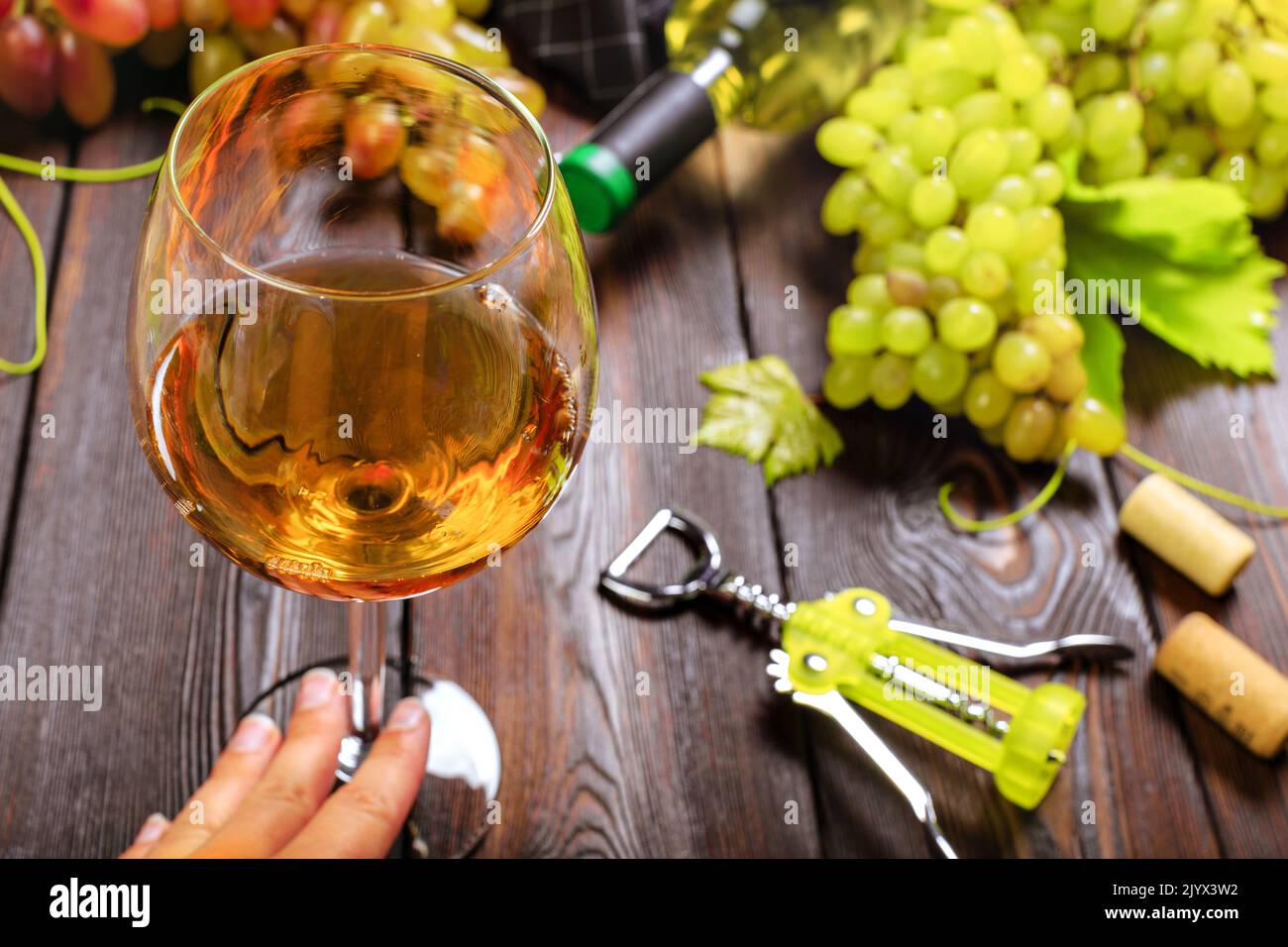 wine with branches of white grapes. On a wooden table Stock Photo - Alamy