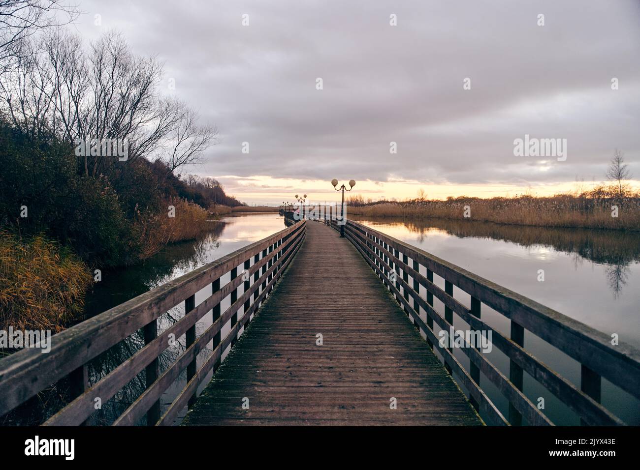 Wooden promenade in the village of Yantarniy. Park wooden walk way ...