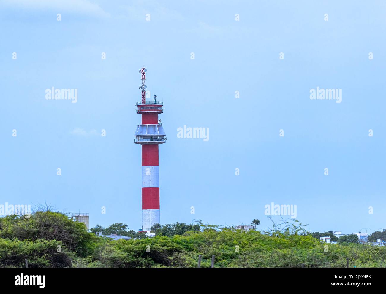 A Lighthouse near a sea beach red and white Stock Photo - Alamy