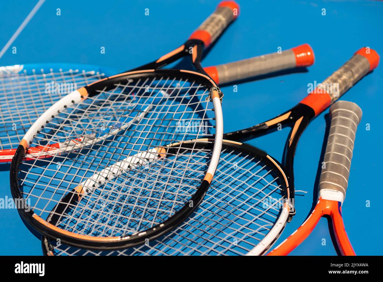 broken tennis rackets on clay tennis court Stock Photo - Alamy