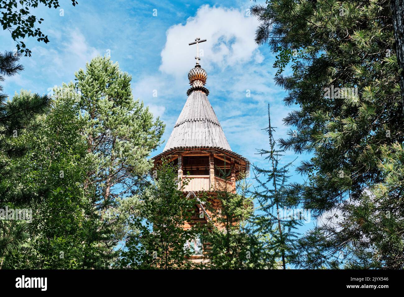 Dome and bell tower of modern log hipped-roof church. Russian wooden ...