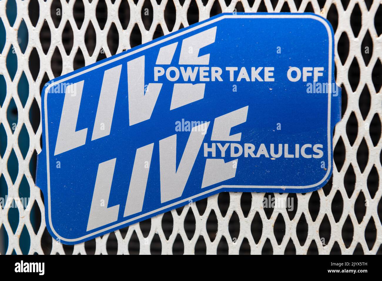 Close up of a plaque reading live power take off and live hydraulics on ...