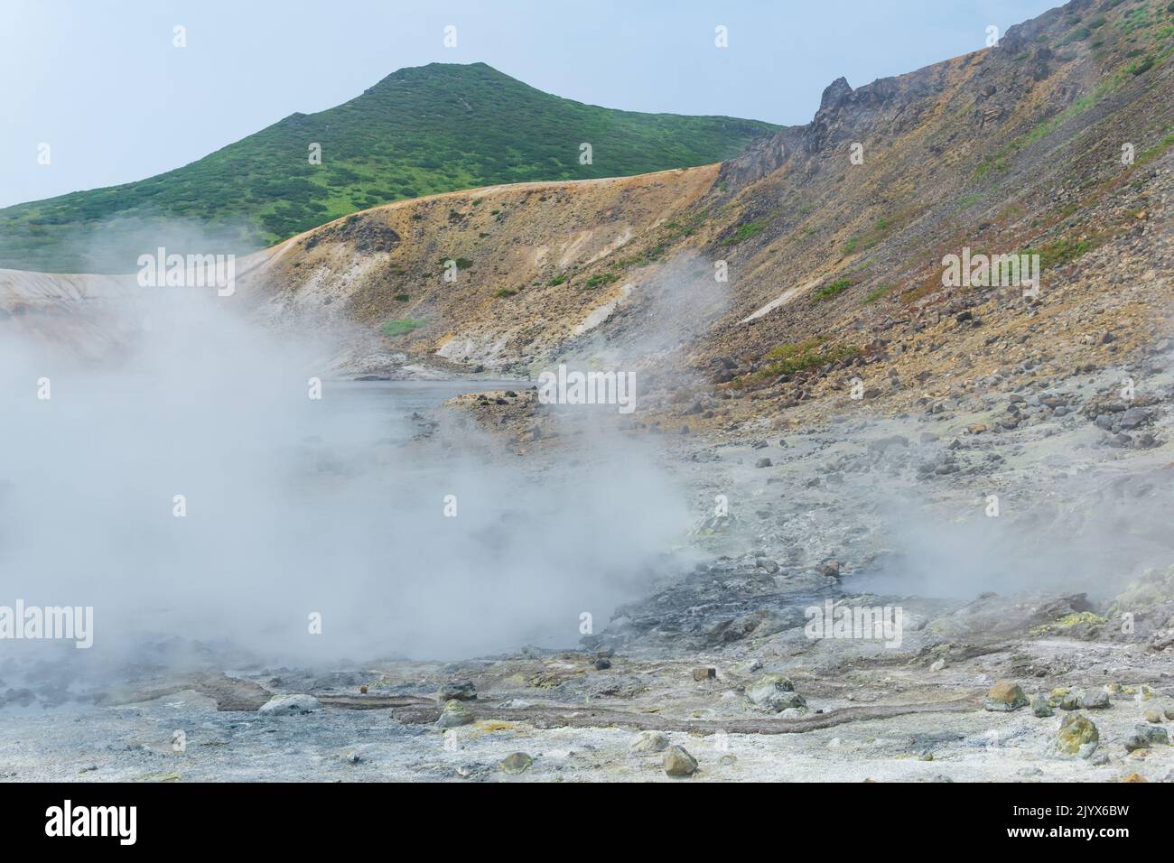 steaming hydrothermal outlet on the shore of the hot lake in the ...