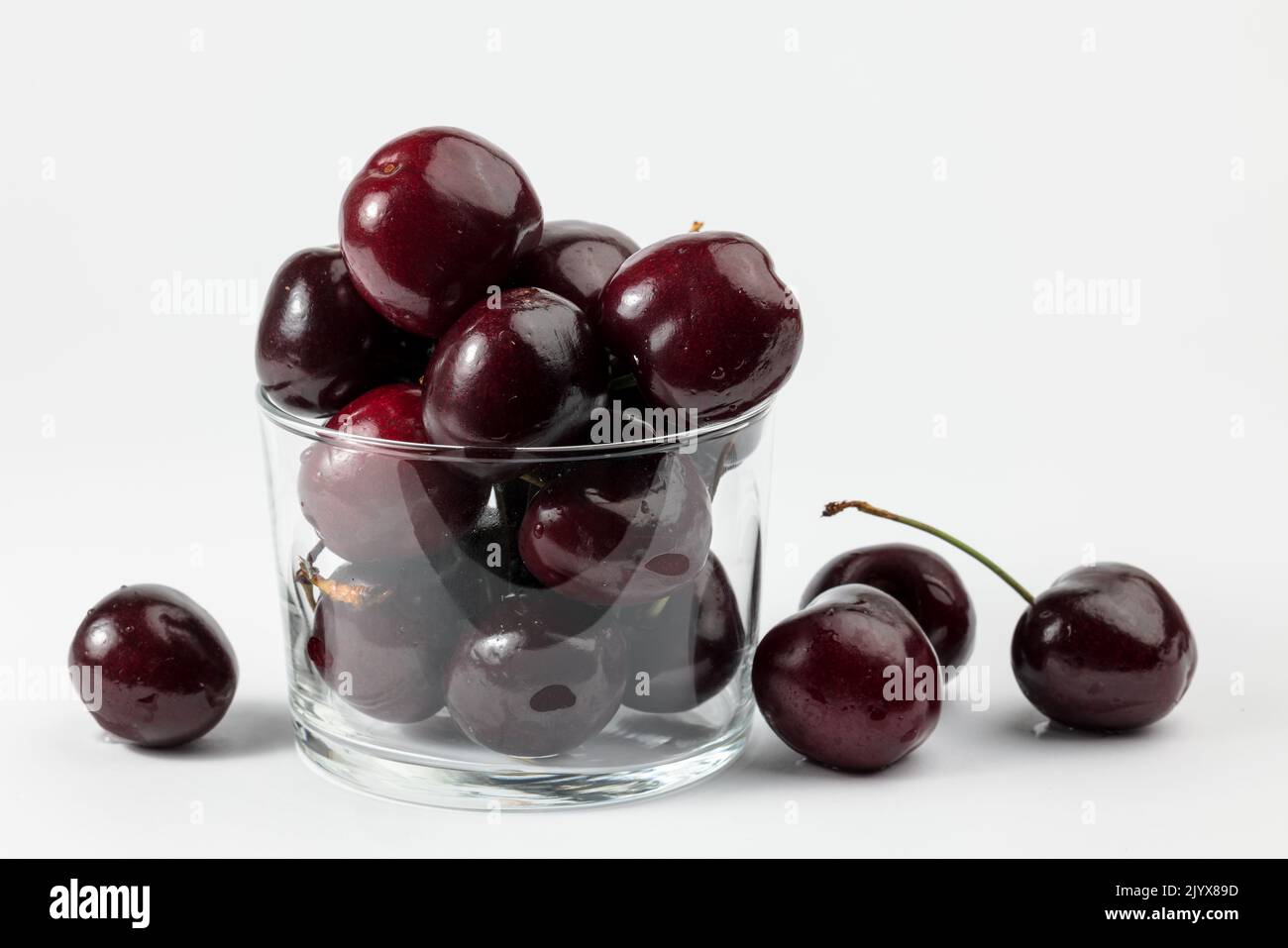 A few delicious cherries on white background Stock Photo - Alamy