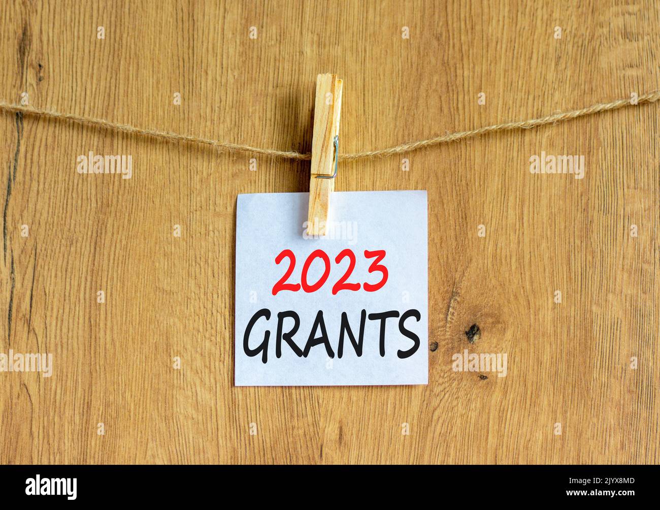 2023 Grants symbol. White paper with words 2023 Grants, clip on wooden ...