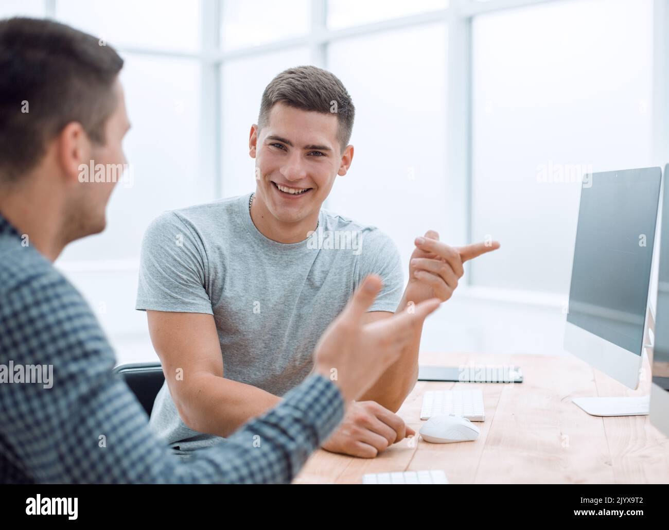Young employees sitting office hi-res stock photography and images - Alamy