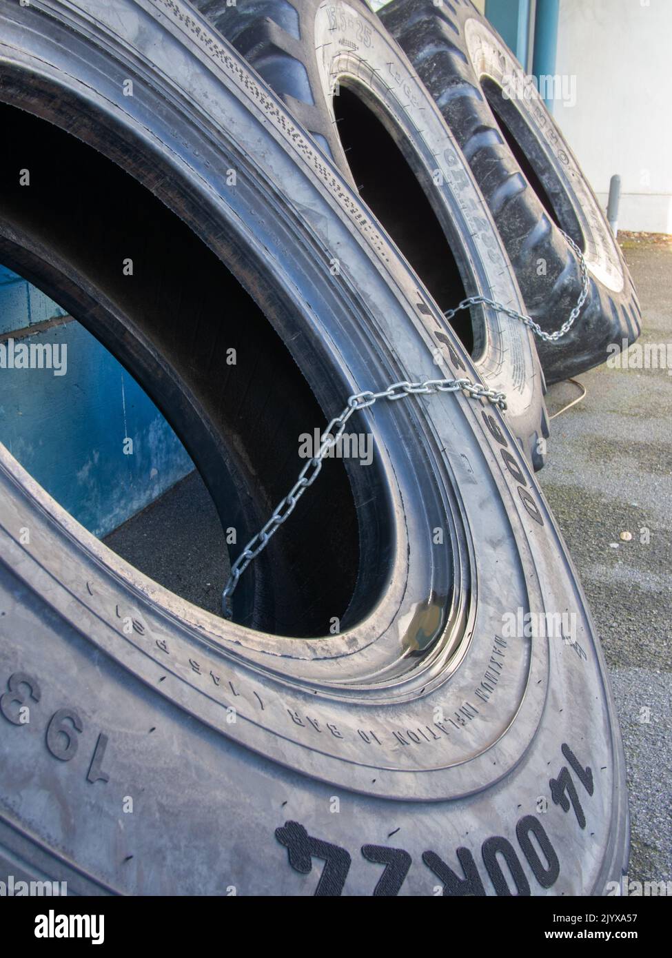 Large Tyres Chained Together Stock Photo - Alamy