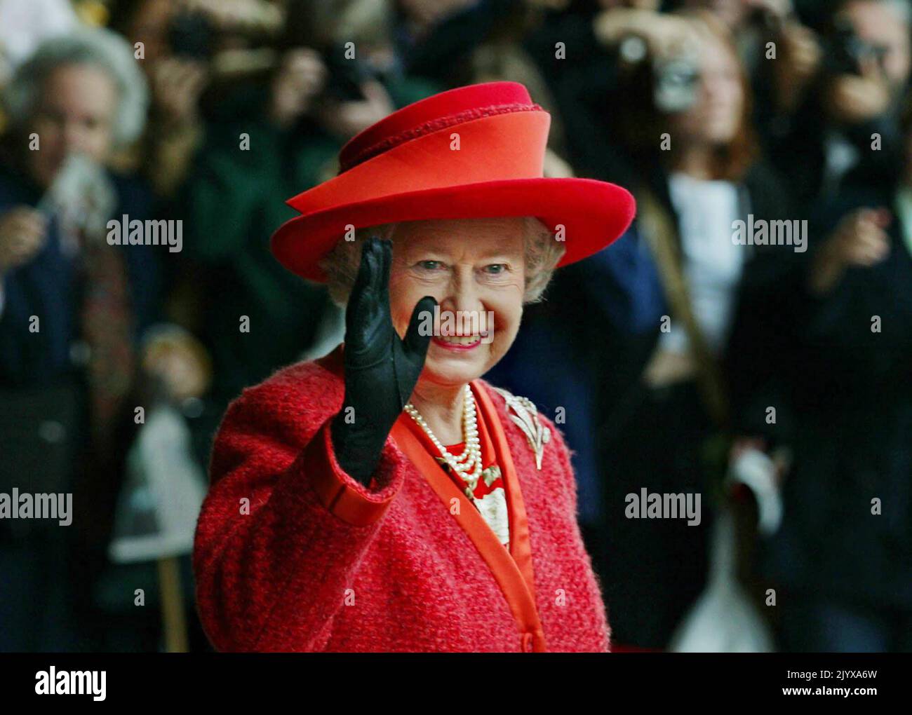 Queen Elizabeth II waves as she leaves the Royal York Hotel in Toronto ...