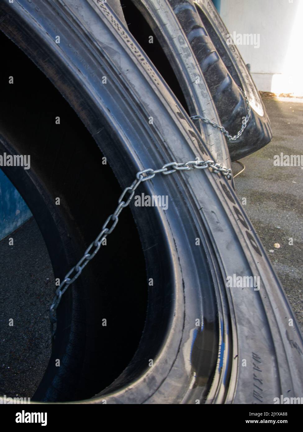 Large Tyres Chained Together Stock Photo - Alamy