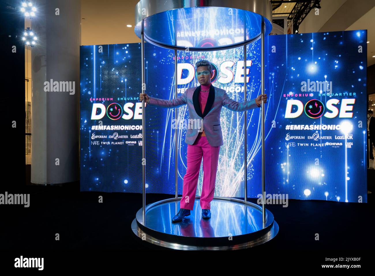 An attendee dressed in haute couture poses for a photo at the entrance of the metaverse fashion ...