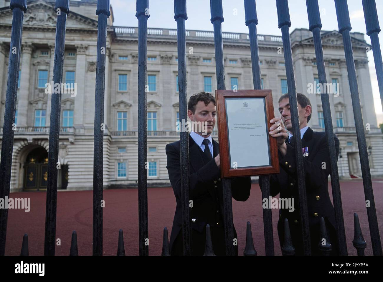 Members of royal household staff posts a notice on the gates of the ...