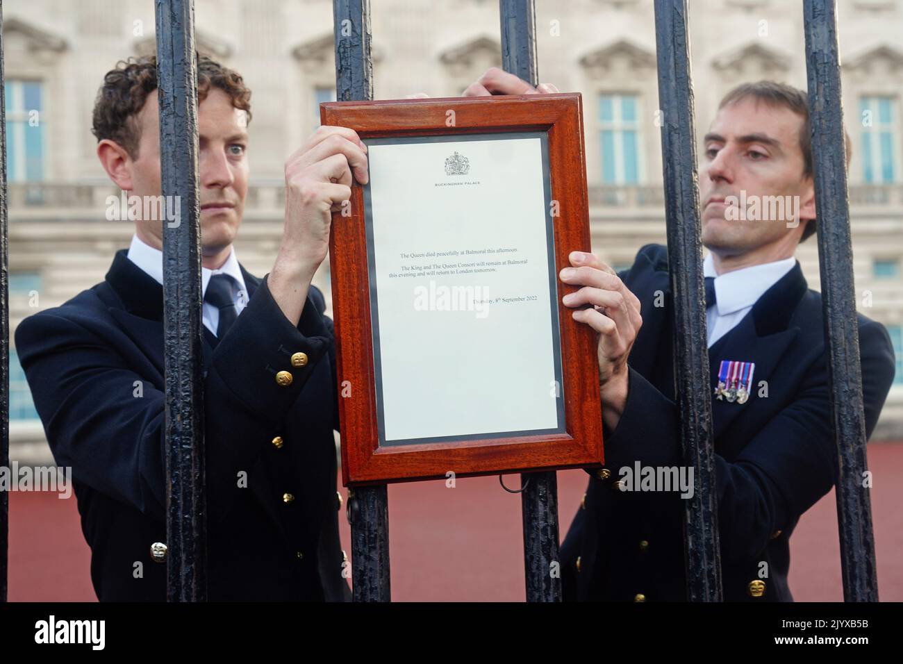Members of royal household staff posts a notice on the gates of the ...