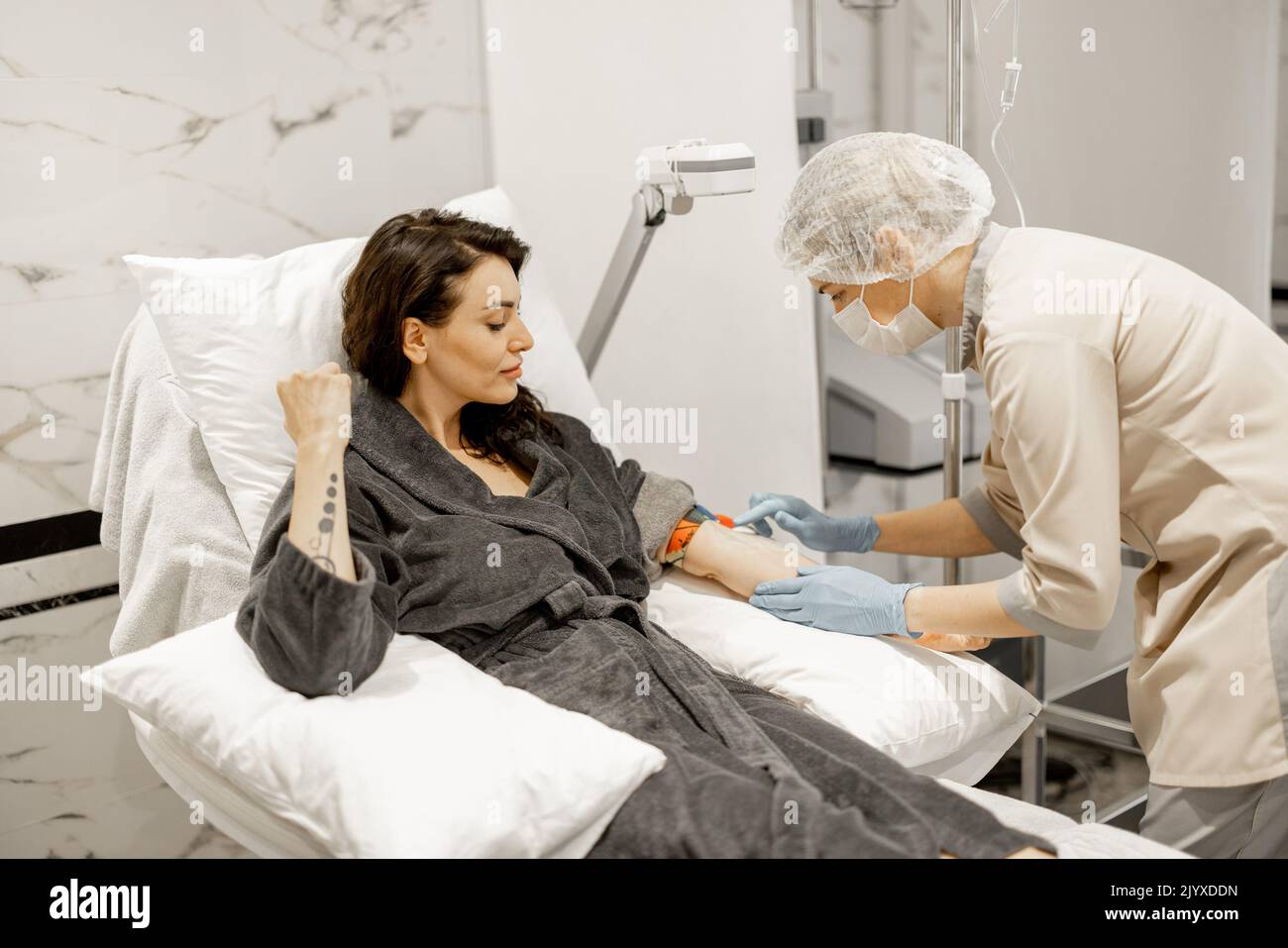 Woman with nurse during blood washing procedure at medical centre Stock ...