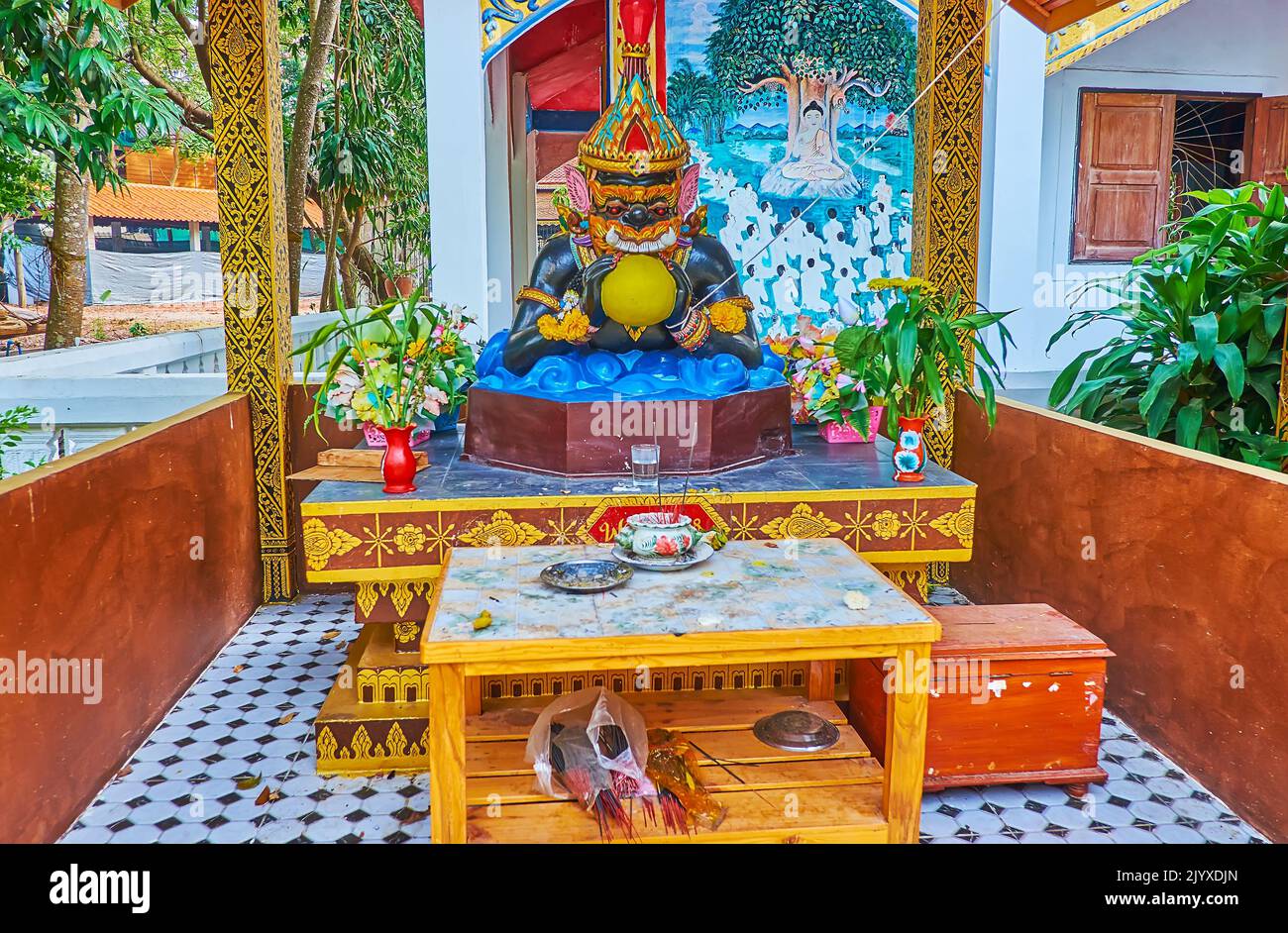 The statue of Yaksha in a small pavilion of the shrine in Wat Klang ...