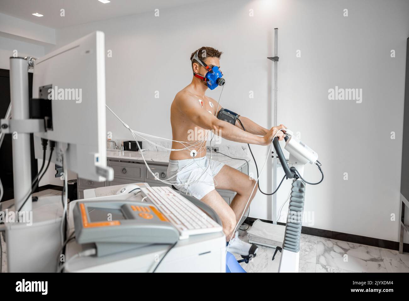 Man examining his cardiovascular system on bike simulator Stock Photo ...