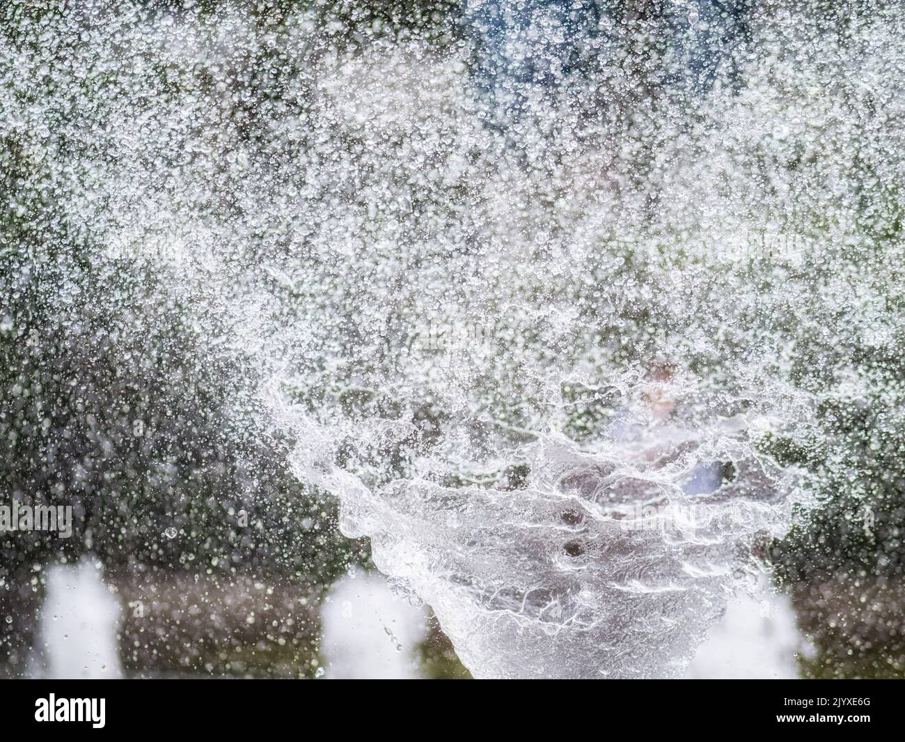 Water splashes from fountain on dark background. Natural texture of ...