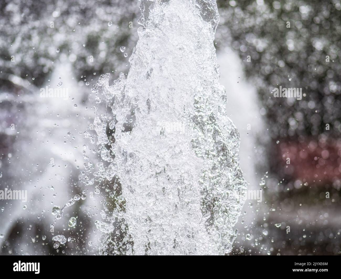 Water splashes from fountain on dark background. Natural texture of ...