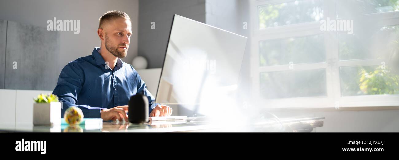 Employee Working On Desktop Computer In Home Office Stock Photo - Alamy