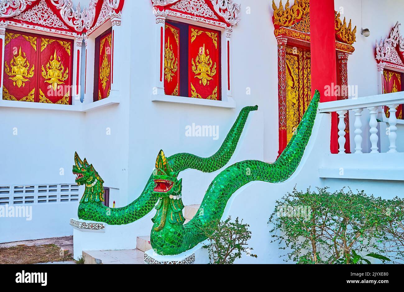 The bright green Naga serpents, covered with mosaic of mirror pieces ...