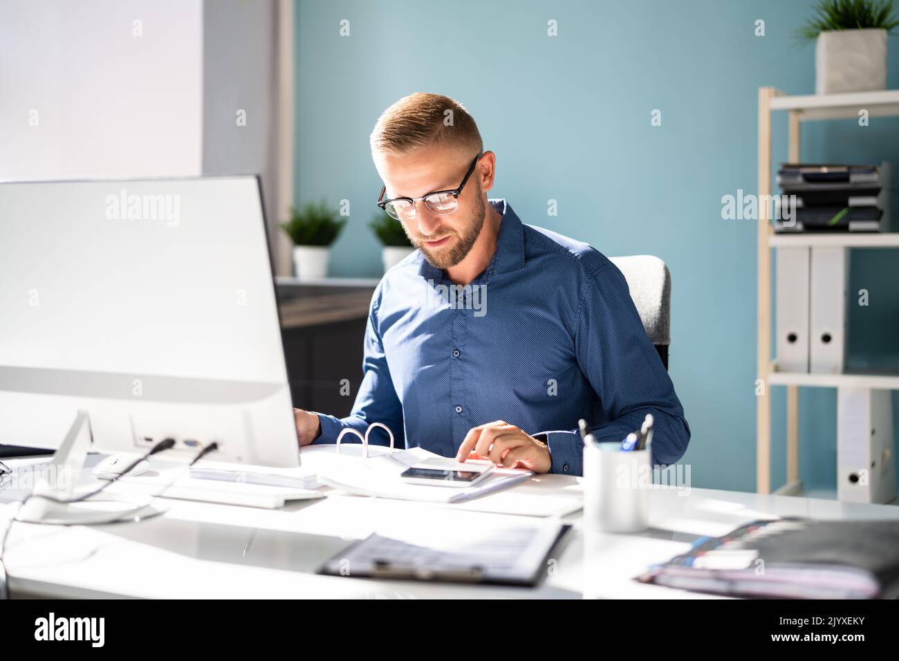 Young male bookkeeper calculator hi-res stock photography and images ...