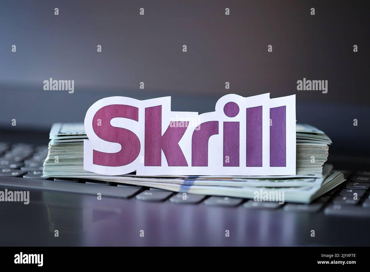 TERNOPIL, UKRAINE - SEPTEMBER 6, 2022 Skrill paper logotype lies on ...