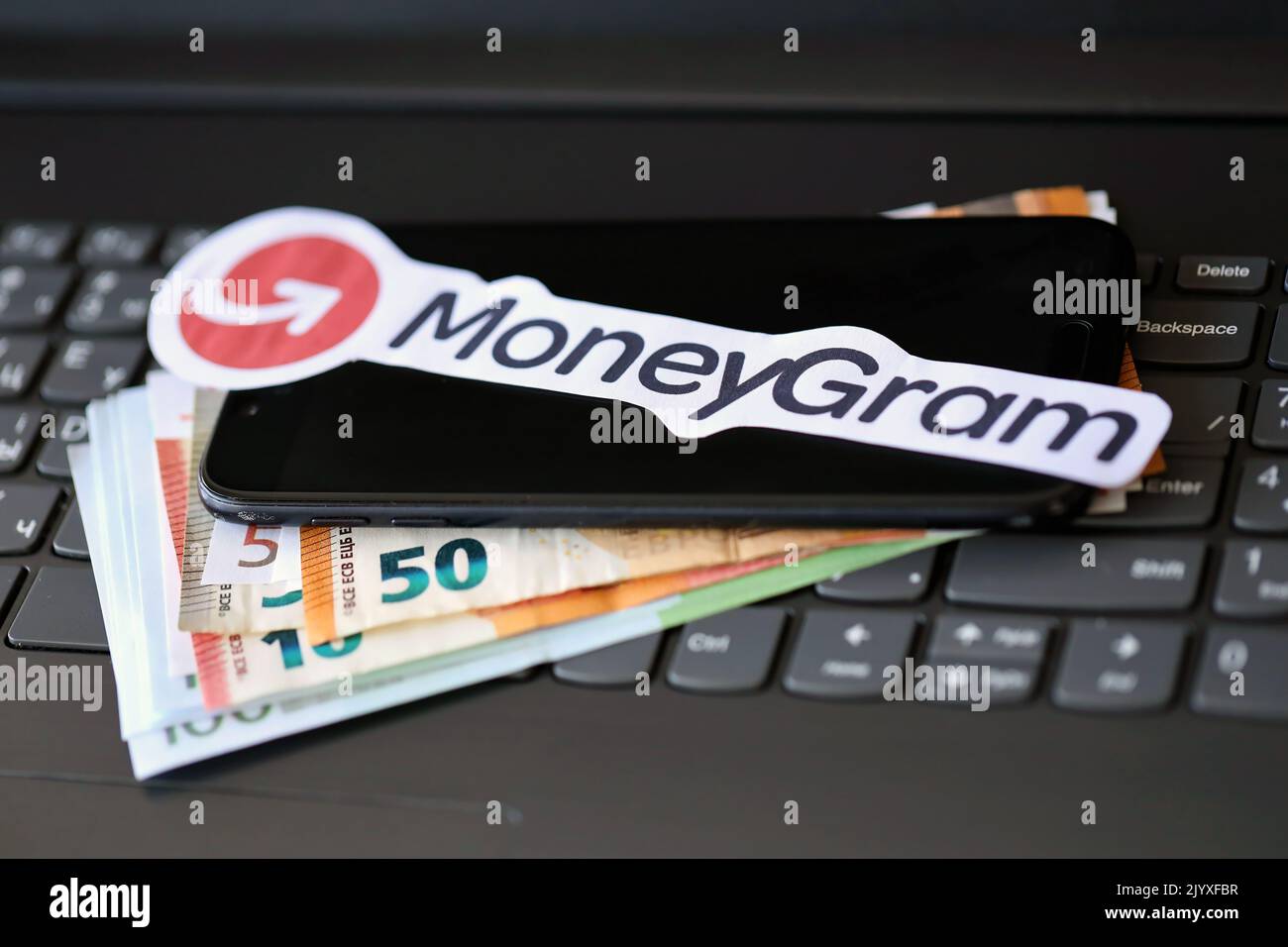TERNOPIL, UKRAINE - SEPTEMBER 6, 2022 MoneyGram paper logotype lies on ...