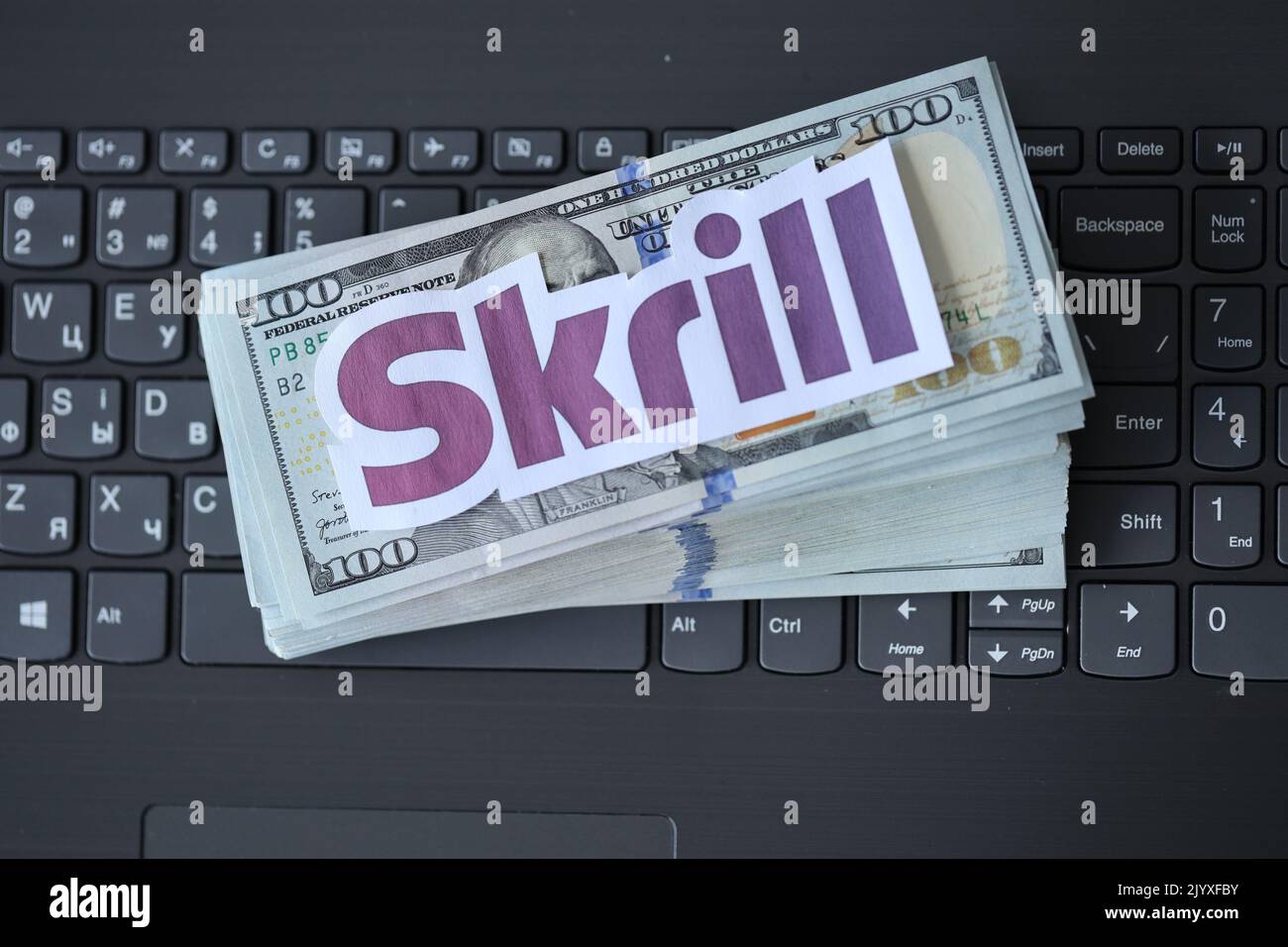 TERNOPIL, UKRAINE - SEPTEMBER 6, 2022 Skrill paper logotype lies on ...