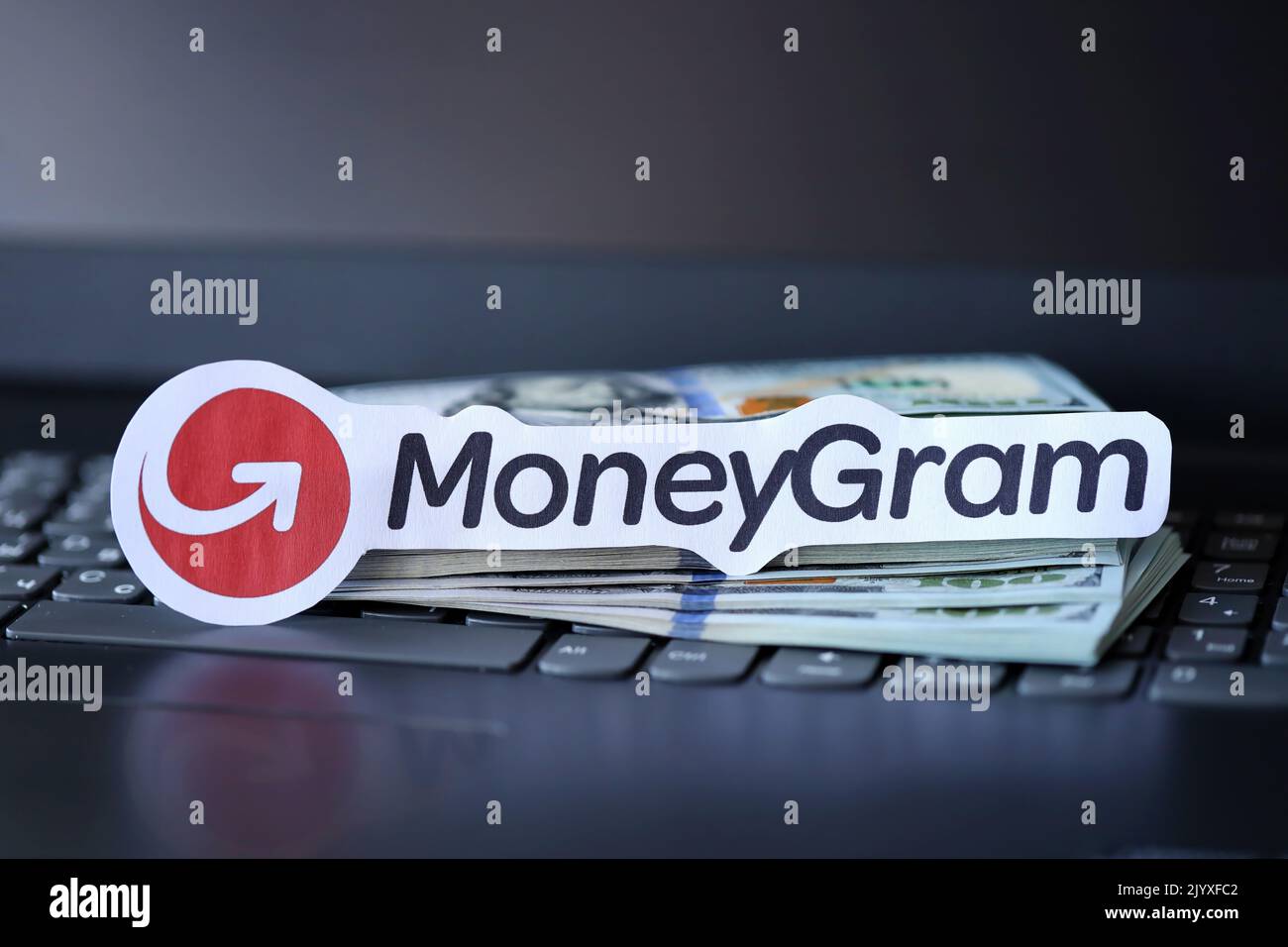 TERNOPIL, UKRAINE - SEPTEMBER 6, 2022 MoneyGram paper logotype lies on ...