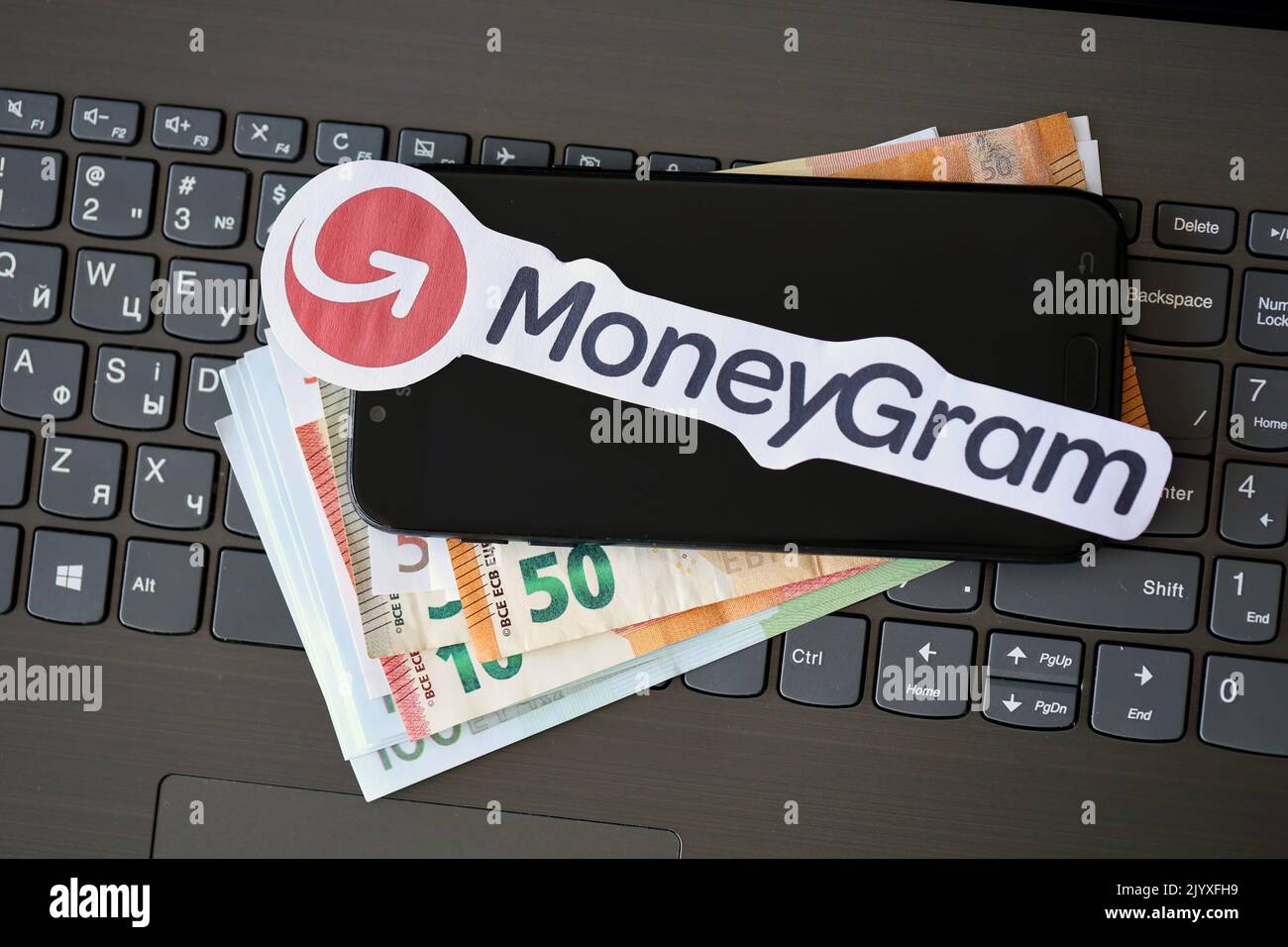 TERNOPIL, UKRAINE - SEPTEMBER 6, 2022 MoneyGram paper logotype lies on ...