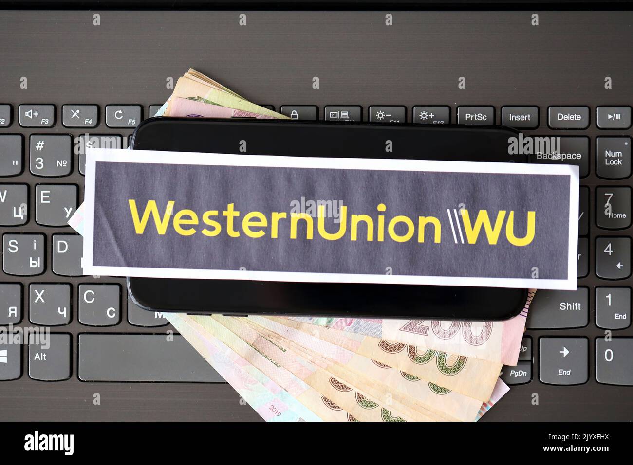 TERNOPIL, UKRAINE - SEPTEMBER 6, 2022 Western Union paper logotype lies ...