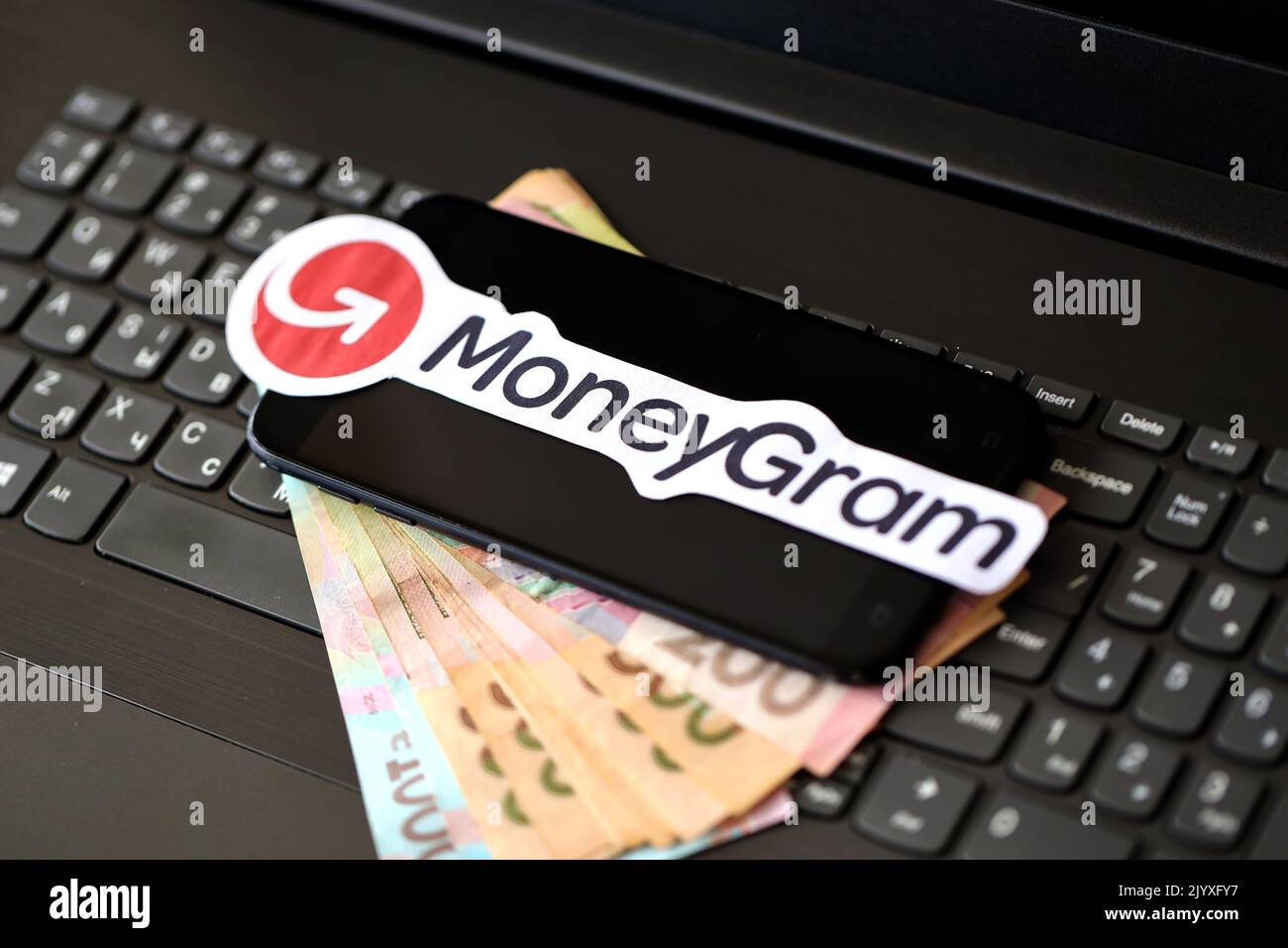 TERNOPIL, UKRAINE - SEPTEMBER 6, 2022 MoneyGram paper logotype lies on ...