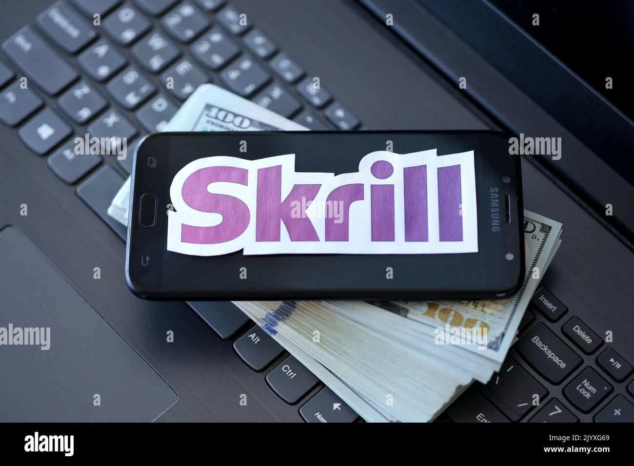 TERNOPIL, UKRAINE - SEPTEMBER 6, 2022 Skrill paper logotype lies on ...