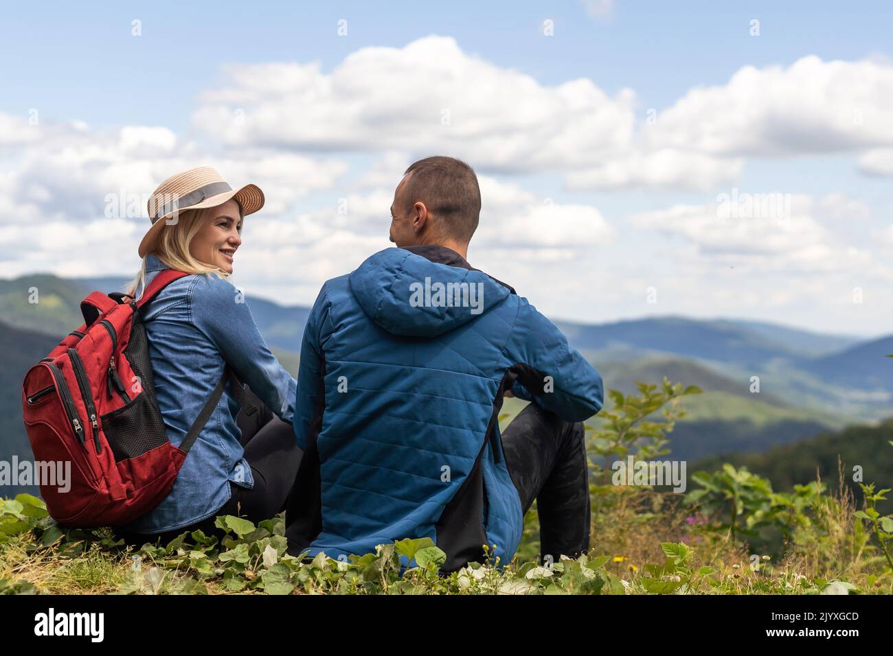 Portrait of beautiful young couple enjoying nature at mountain peak Stock Photo - Alamy