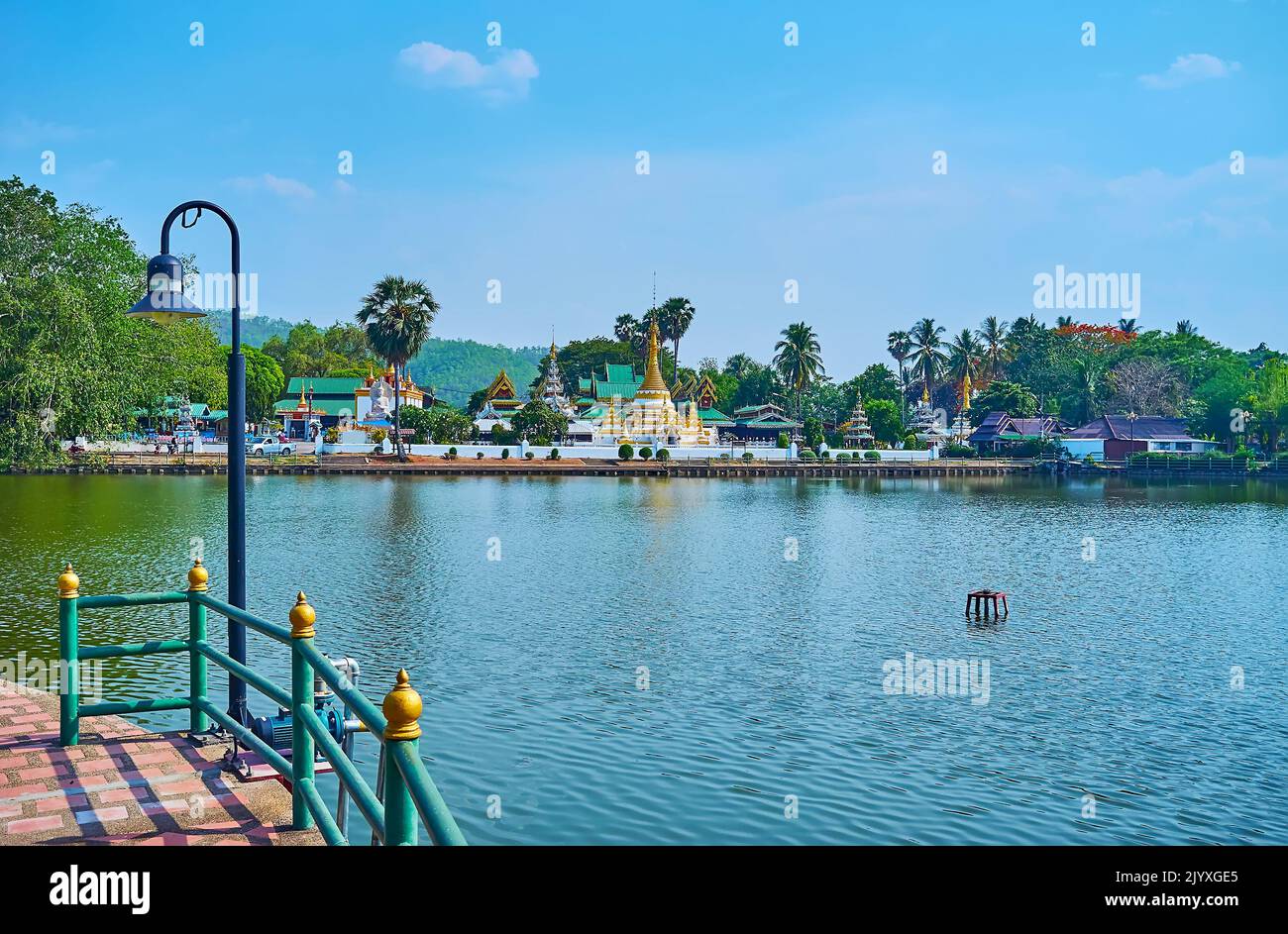 Walk by the Nong Kham lake and observe the stunning Wat Chong Kham and ...