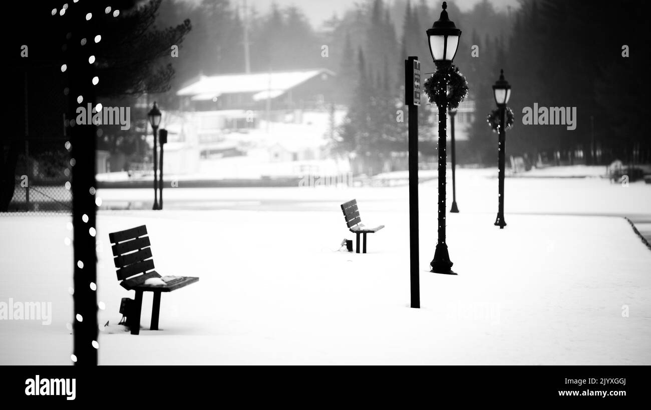 Empty winter benches after a snowstorm in Old Forge, New York Stock ...