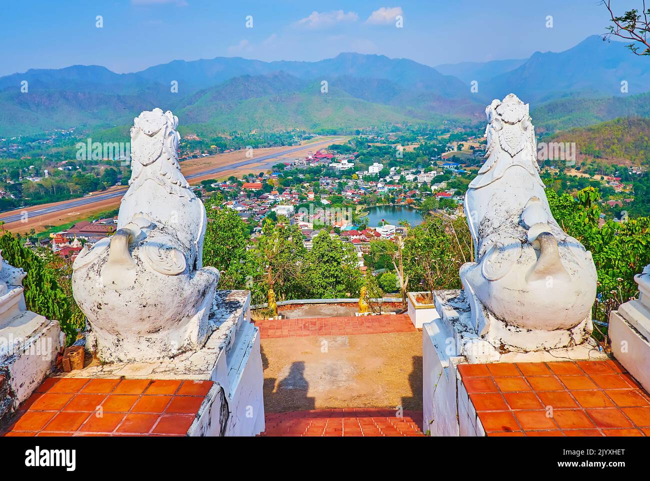 The vintage statues of white Chinthe (Singha) lions on both sides of ...