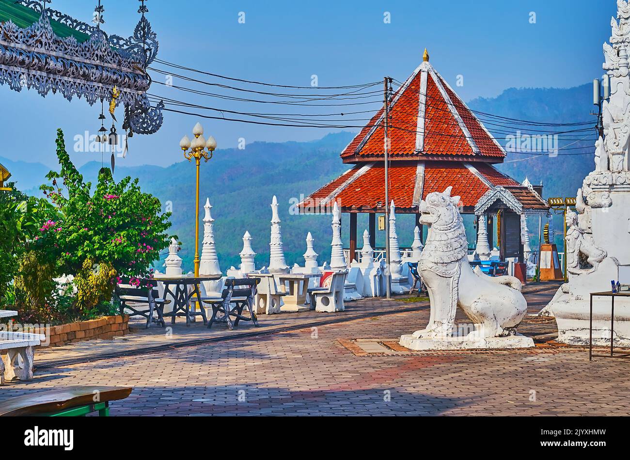 The vintage white statue of Chinthe (Singha) lion on grounds of Wat ...